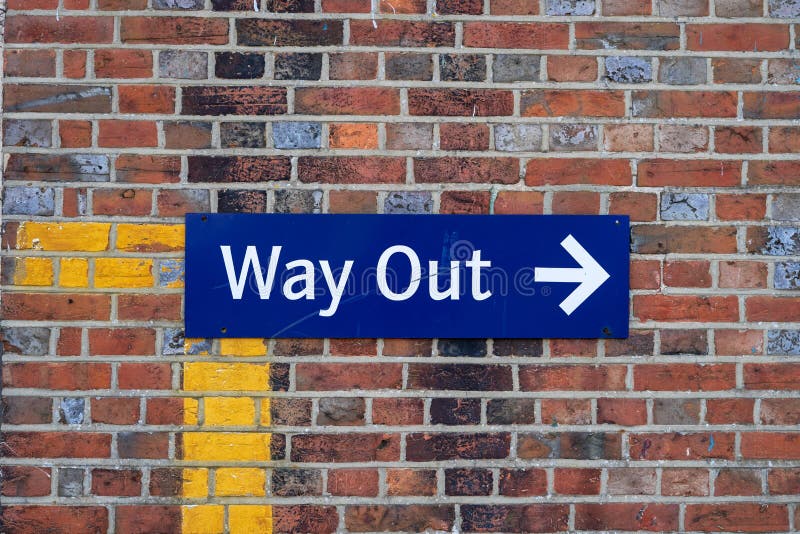 A Blue Way Out Sign on a Brick Wall Stock Photo - Image of brick, blue ...