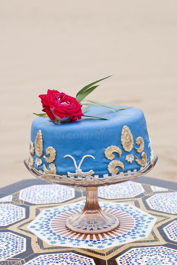 Blue Wedding Cake on a Table and Red Roses on Top Stock Image - Image ...