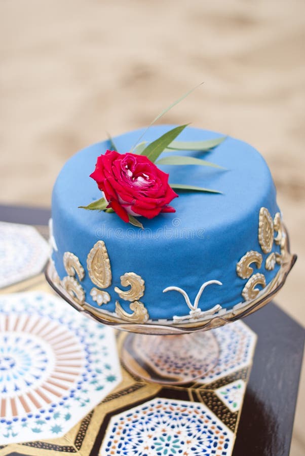 Blue Wedding Cake on a Table and Red Roses on Top Stock Image - Image ...
