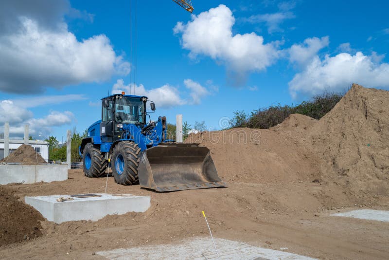 A Blue Wheel Loader Stands on a Construction Site Editorial Image ...