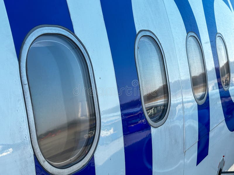 The Blue and White Airplane Has a Large Window on the Side Stock Photo ...