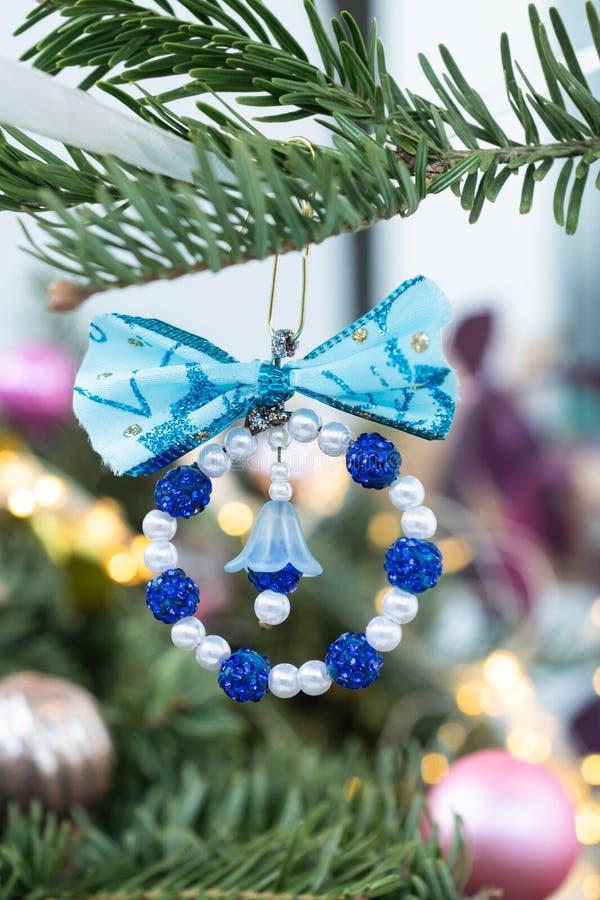 Blue and White Beaded Christmas Ornament with Bow on Evergreen Tree ...