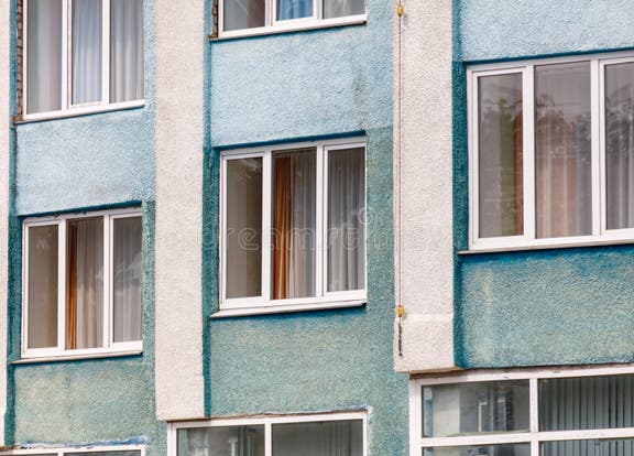 A Blue and White Building with Many Windows Stock Image - Image of ...