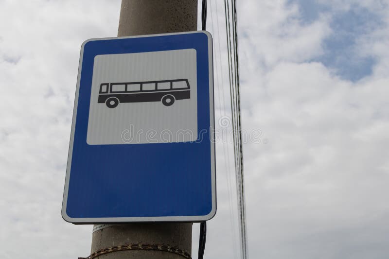 A Blue and White Bus Stop Sign with an Icon of Public Transportation on ...