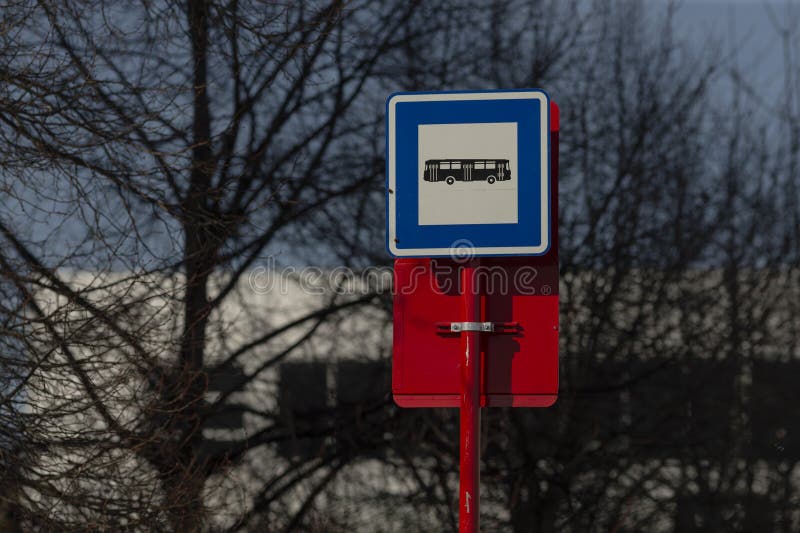 A Blue and White Bus Stop Sign Mounted on a Tall Red Pole Stock Photo ...