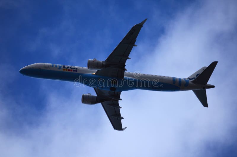 Blue and White Commercial Airplane Flying Left in Low Altitude ...