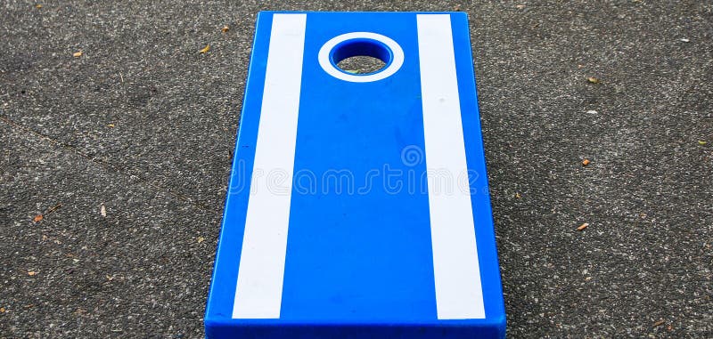 Blue and White Cornhole Game on a Black Tar Street Stock Image - Image ...