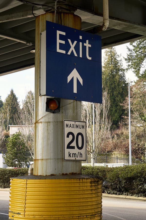 A Blue and White Exit Sign with an Arrow Pointing the Direction and a ...