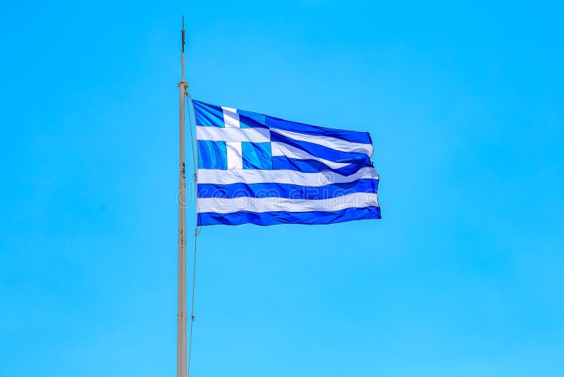 A Blue and White Flag with Cross on it is Flying in the Sky, Greek Flag ...