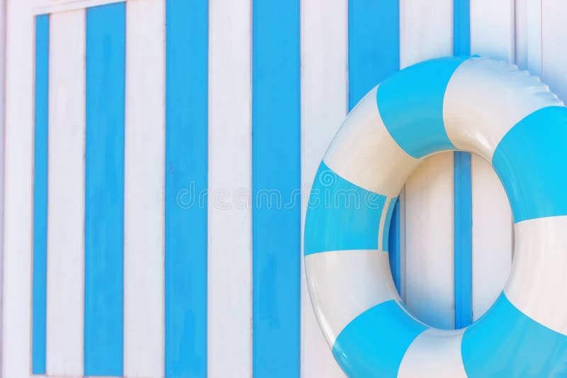 Blue and White Inflatable Ring on Striped Wall, Beach and Pool Safety ...