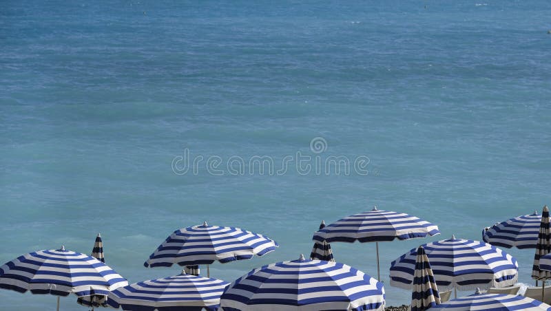 Blue and White Parasols at the Beach in Nice Stock Image - Image of ...