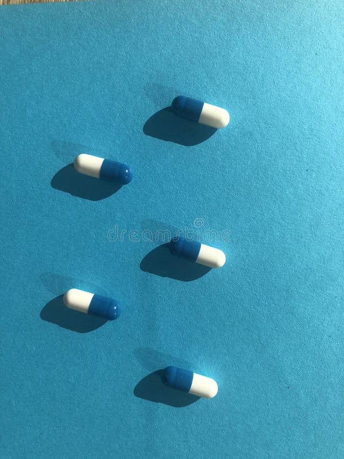 Blue and White Pills on Blue Background Stock Photo - Image of ...