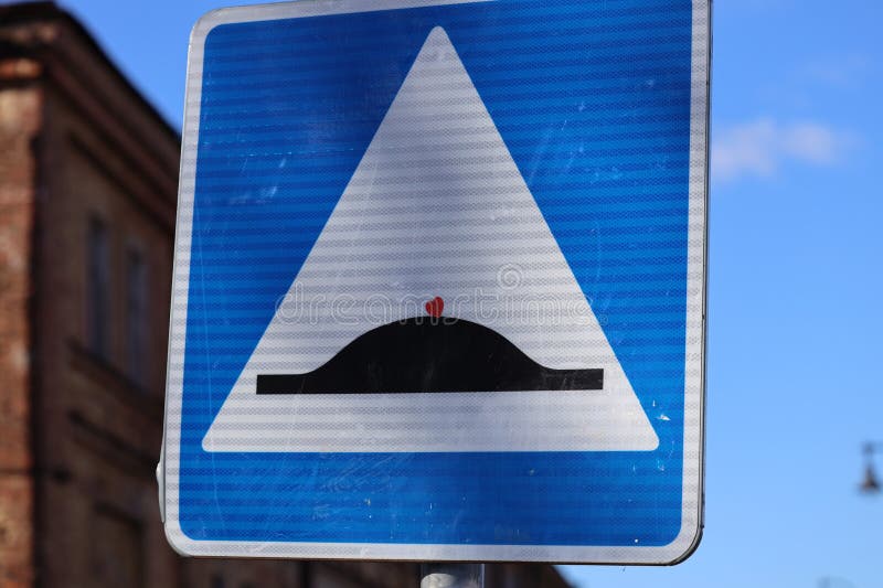 A Blue and White Street Sign with a Red Dot Indicating Direction or ...