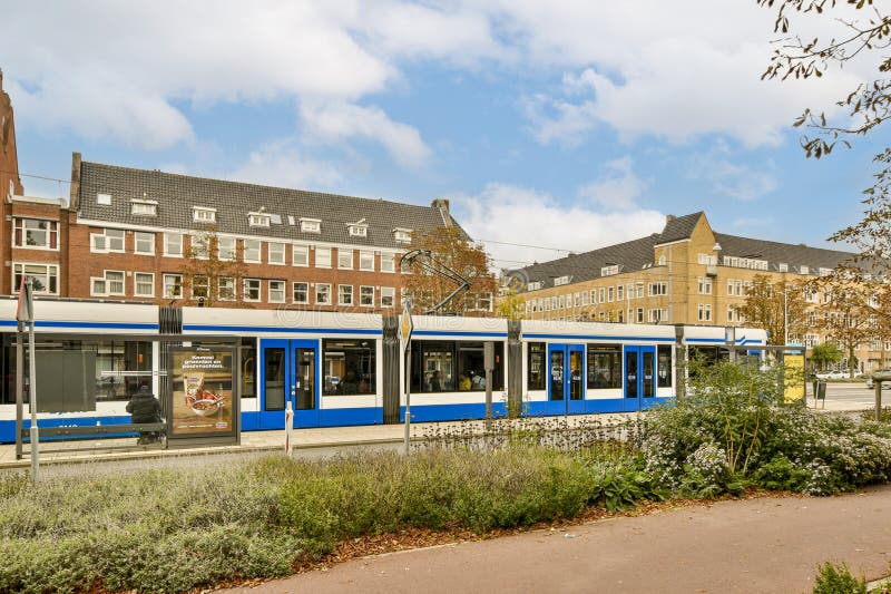 A Blue and White Train in Front of a Building Editorial Stock Image ...