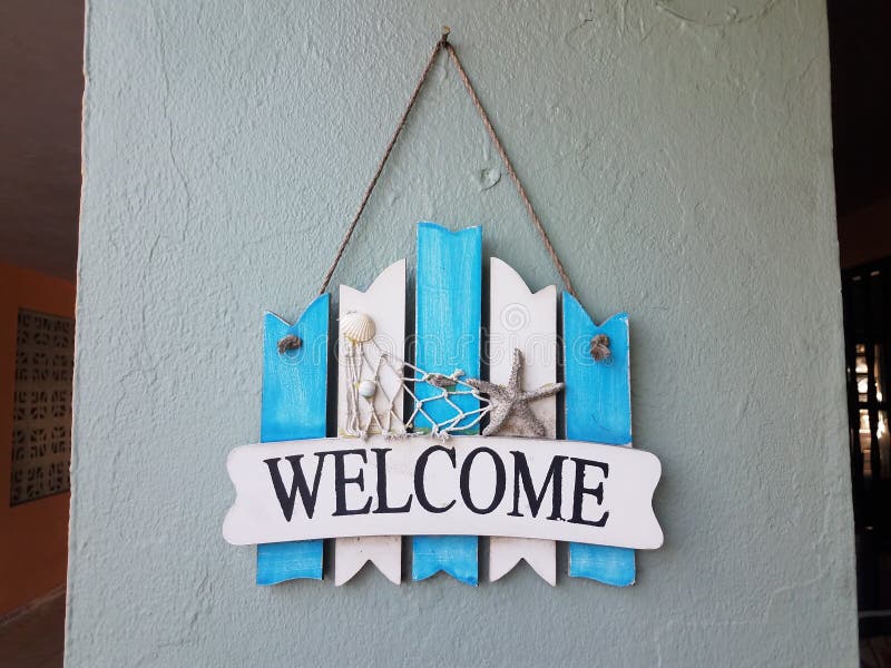 Blue and White Welcome Sign with Shells on Wall Stock Photo - Image of ...