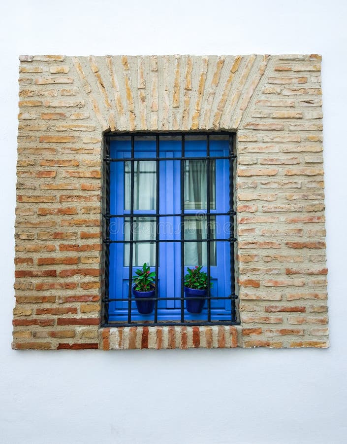 Blue Window in Brick Wall Inside a Cordovan Patio, with Flower Pots ...
