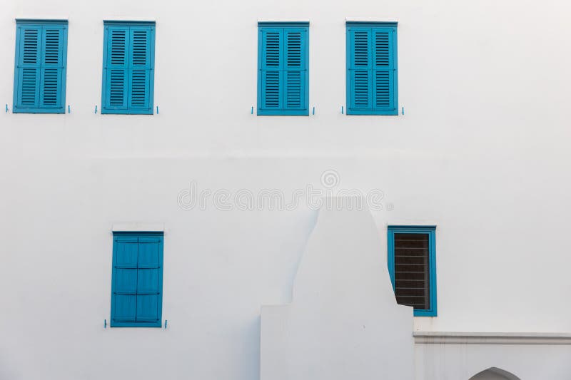 Blue Windows with Shutters on White Wall. Stock Image - Image of ...