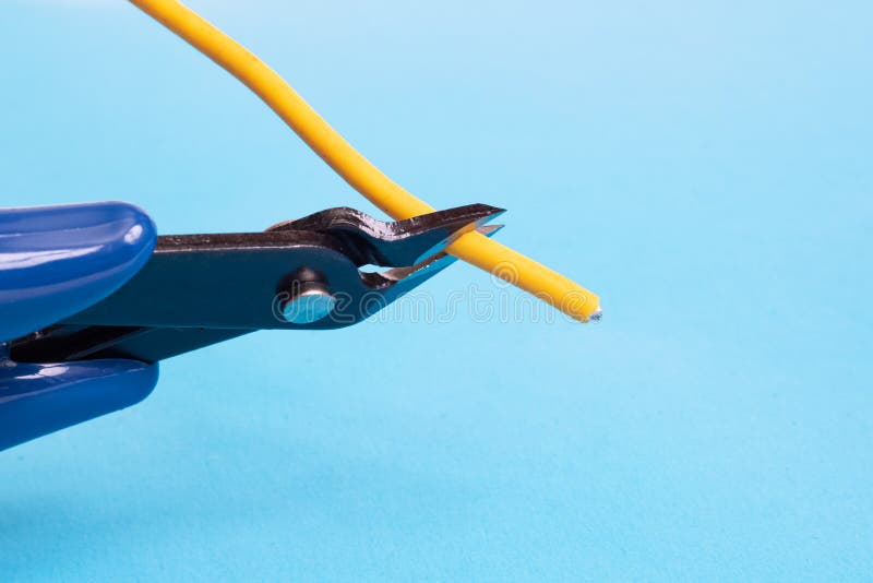 Blue Wire Cutter Cuts Yellow Wire on Blue Background Stock Photo ...