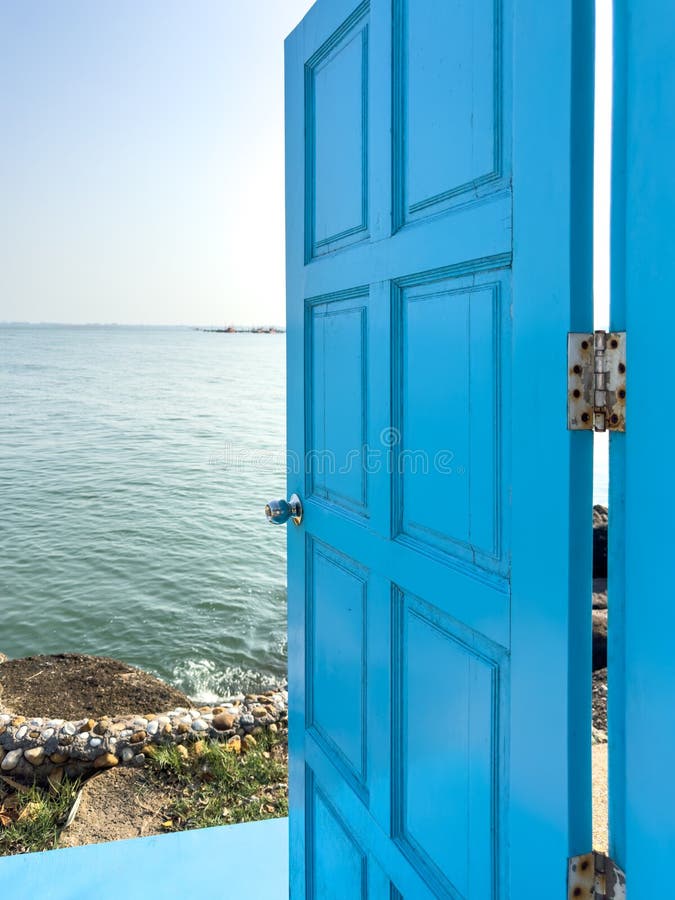 Blue Wooden Door Open To the Sea Stock Photo - Image of house, sunlight ...