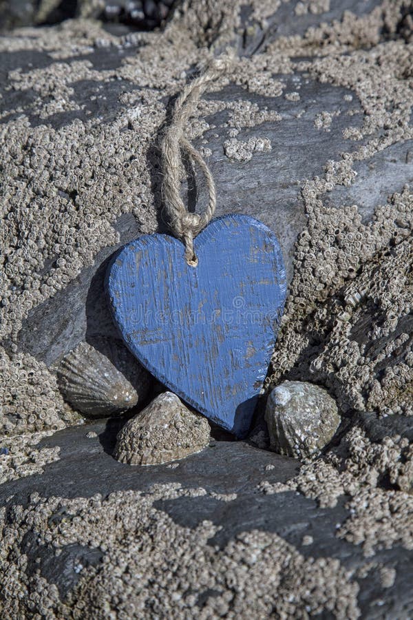 Blue Wooden Heart on Rock stock photo. Image of blue - 163188380