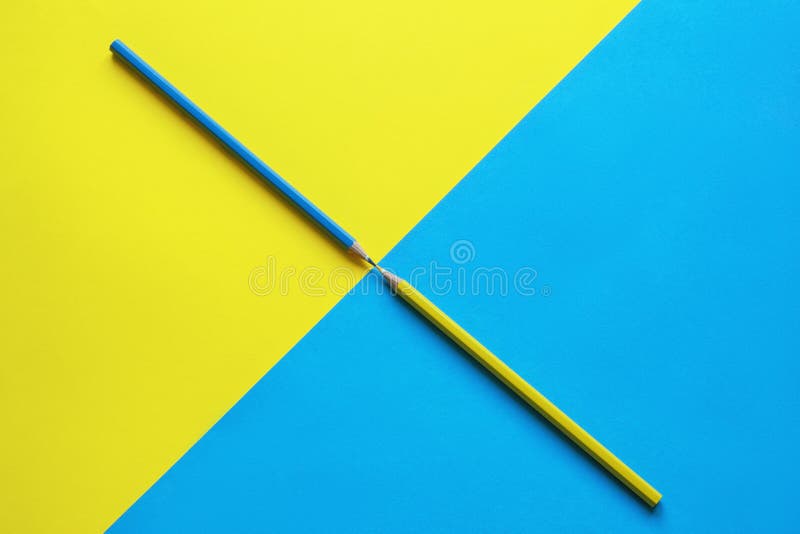 Blue and Yellow Colored Pencils on Blue and Yellow Paper Background ...