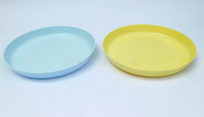 Blue and Yellow Empty Plastic Plates on White Stock Image - Image of ...