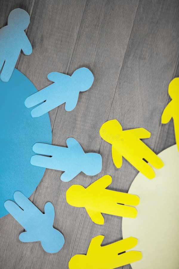 Blue and Yellow Paper Cut Out Figures on Wooden Table Stock Image ...
