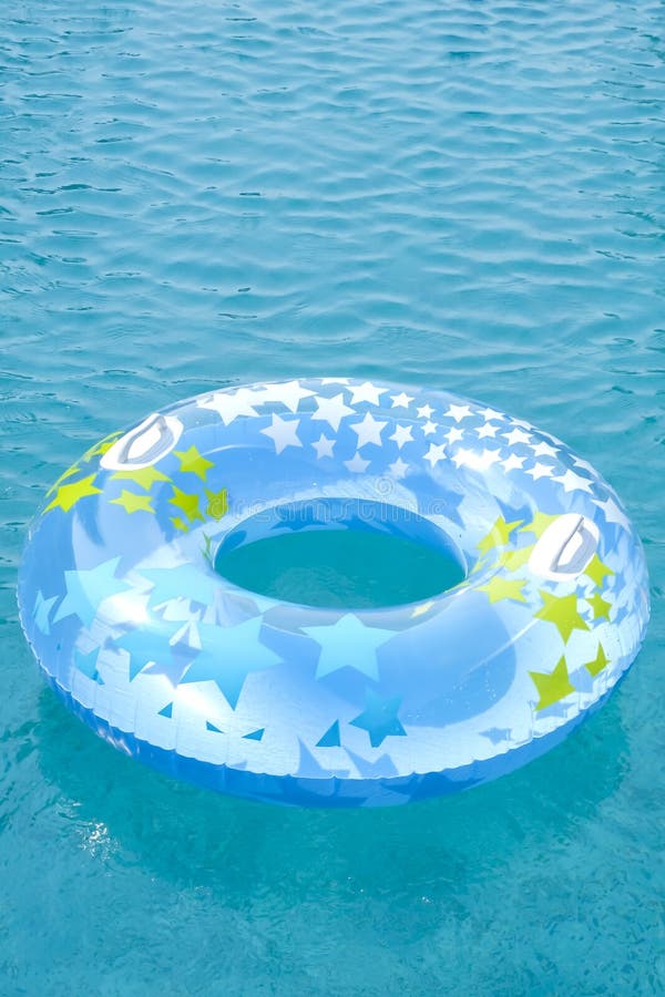 Blue And Yellow Pool Float, Ring Floating In A Refreshing Blue Swimming ...