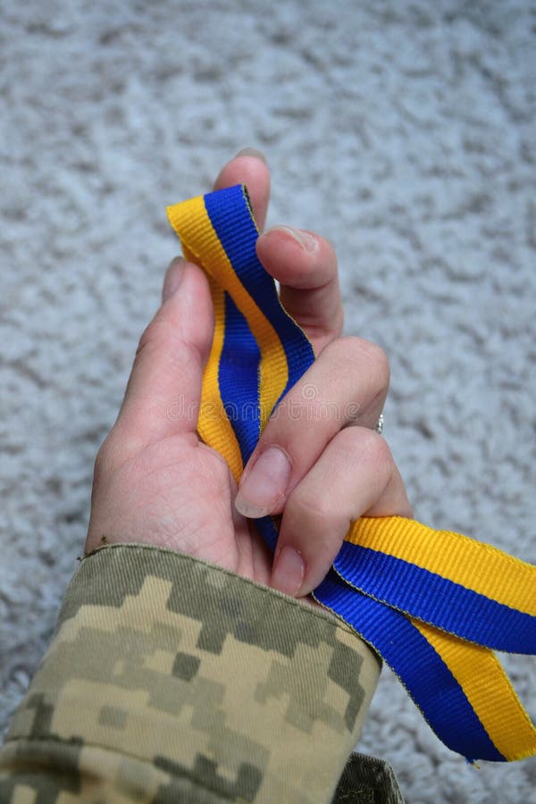 A Blue-yellow Ribbon in the Hands of a Military Woman Stock Image ...