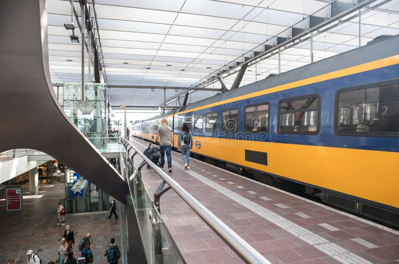 Blue and Yellow Train Standing on a Platform with Interior of Railway ...
