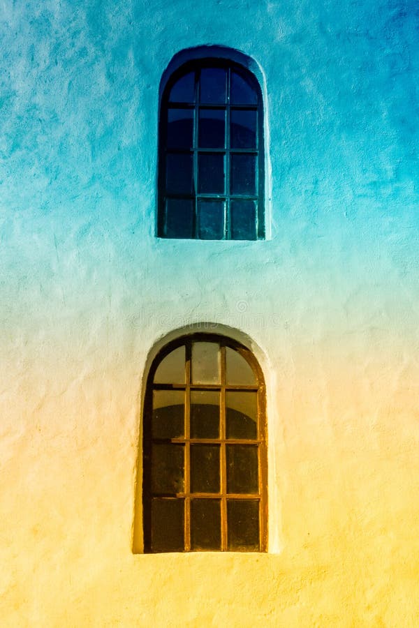 Blue and Yellow Windows on an Ancient White Building Stock Image ...