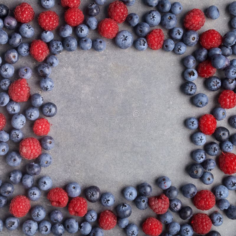 Blueberries and Raspberries Frame on Rusty Grey Background. Top View ...