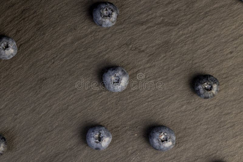 Blueberries Scattered on a Black Slate Board Stock Photo - Image of ...