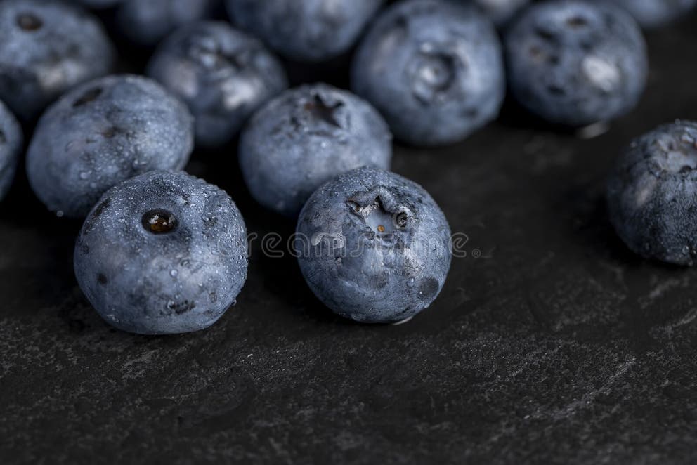 A Pile of Blueberries Scattered on the Board Stock Photo - Image of ...