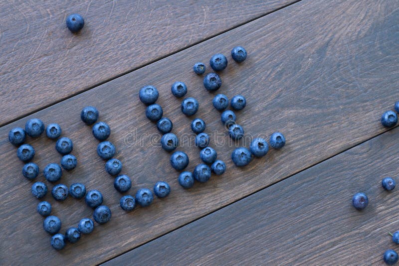Blueberries Spelling Out the Word Blue on a Wood Table Stock Photo ...