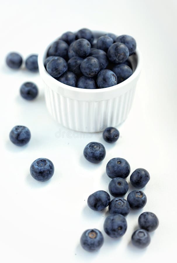 Blueberry Berries in a Clay White Pot with Scattered Berries on a White ...