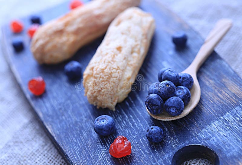 Blueberry Eclairs on a Dark Blue Background Stock Image - Image of ...