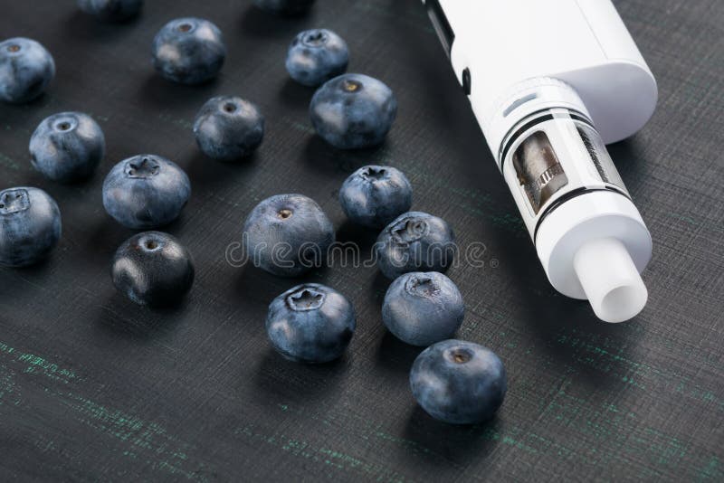 Blueberry and Electronic Cigarette on a Dark Table Stock Photo - Image ...