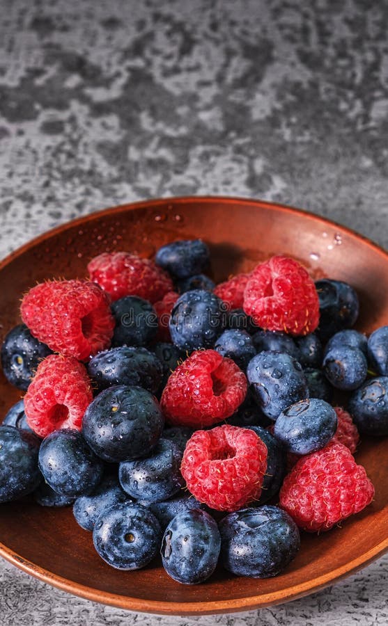 Blueberry and Raspberry in a Clay Plate. Raw Berries Mix Close Up Stock ...