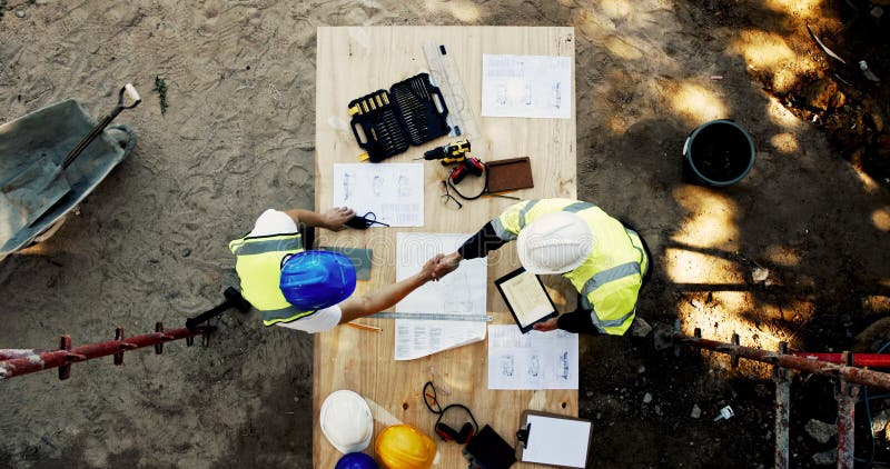 Blueprint, Construction and Men at Table Shaking Hands with Collaboration, Agreement and ...
