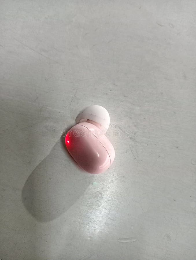 Bluetooth Headset in the Shape of a Pink Capsule Isolated on a White ...