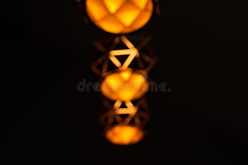A Blurred Background of Black Lamps with a Geometric Pattern, Three ...
