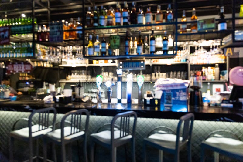 Blurred Bar Counter in Pub with Drinks and Stools Stock Image - Image ...