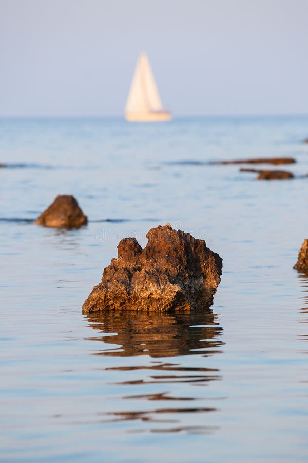 Blurred Boat Behind the Rocks Stock Photo - Image of outdoor, greece ...