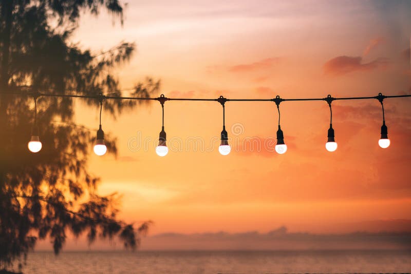 Blurred Light on Sunset with Yellow String Lights Decor in Beach ...