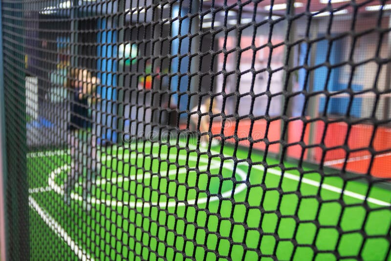 Blurred Children are Playing Behind the Net at Indoor Playground in ...