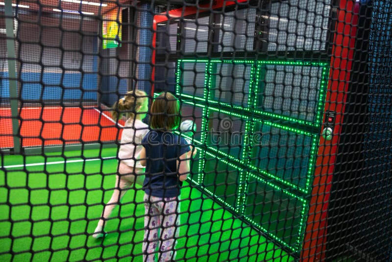 Blurred Children are Playing Behind the Net at Indoor Playground in ...