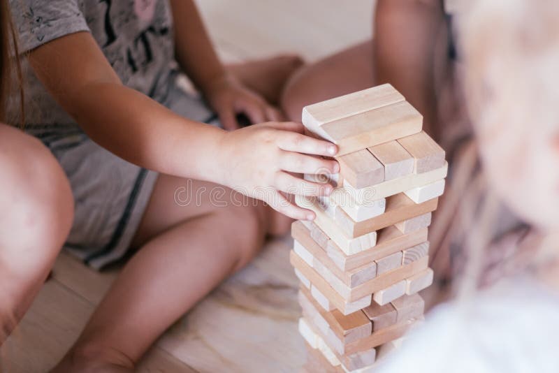 Blurred Childrens Hands Play Game with Tower, Made of Wooden Blocks ...