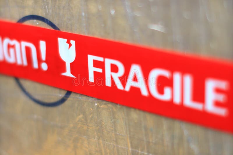 Blurred Close Up Red Fragile Sticker on a Parcel with Shallow Focus ...