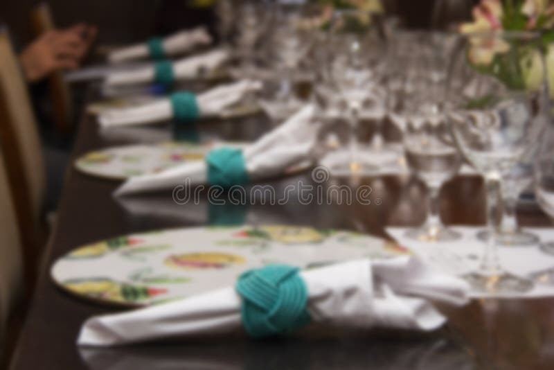 Blurred Dining Table with Bowls and Dishes Set for Dinner and Wine ...